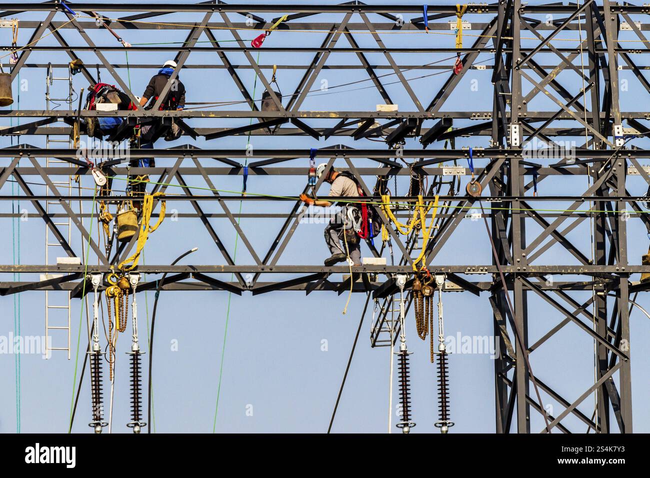 An einem Strommast werden Arbeiten durchgefuehrt. die Infrastruktur ...