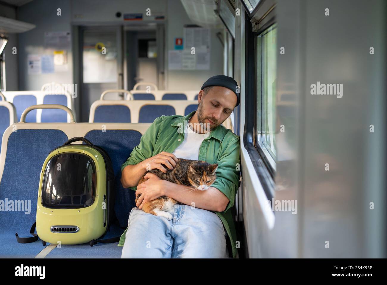 Public electric train ride of thoughtful man hugging calm peaceful ...
