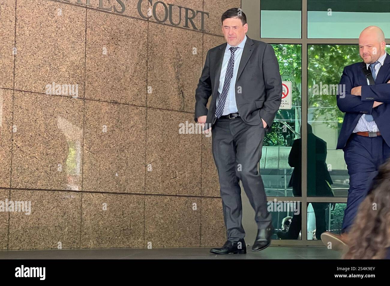 Barrister Anthony Grant (left) leaves the Melbourne Magistrates Court ...