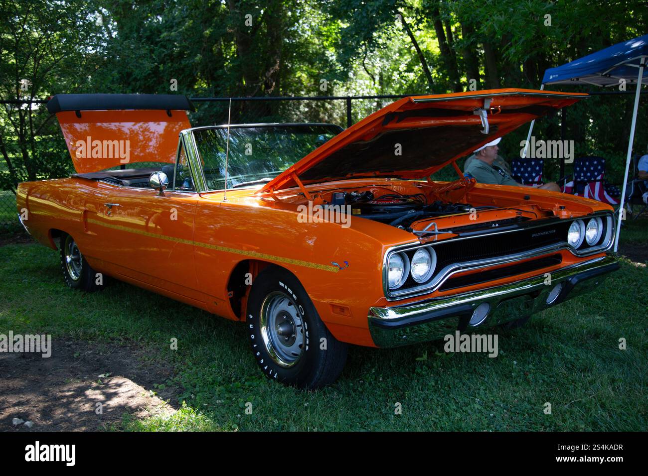 An orange 1970 Plymouth Roadrunner convertible parked in the grass for ...