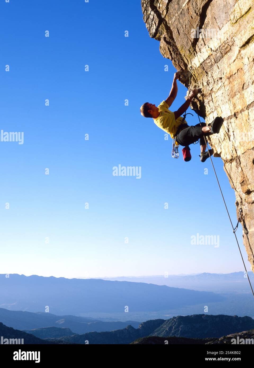 A single male rock climbing an overhanging cliff at Windy Point in the ...