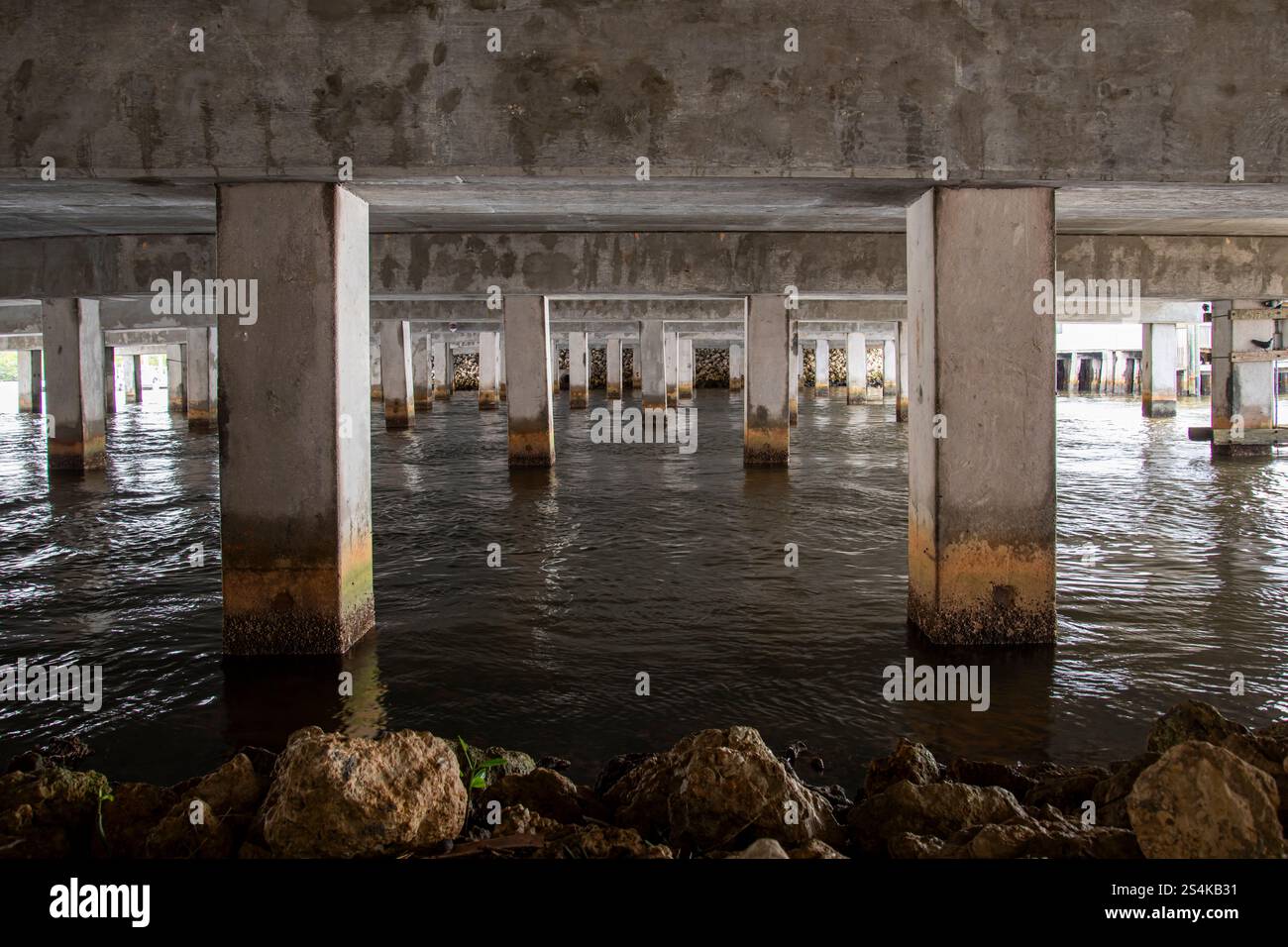 Florida. Bridge pylons under bridge with water showing depth perception ...