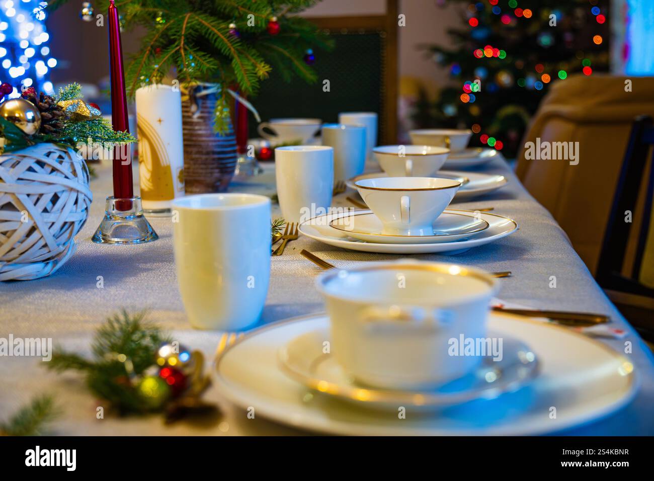 Elegant Christmas Eve table setting with festive decorations and warm ...