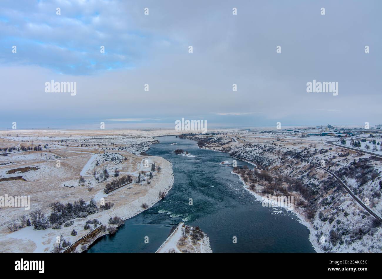 Drone view of a snow covered Great Falls, Montana at sunset in December ...