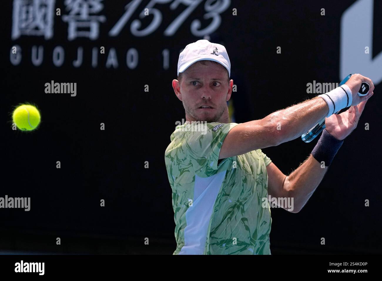 James Duckworth of Australia plays a backhand return to Dominic ...