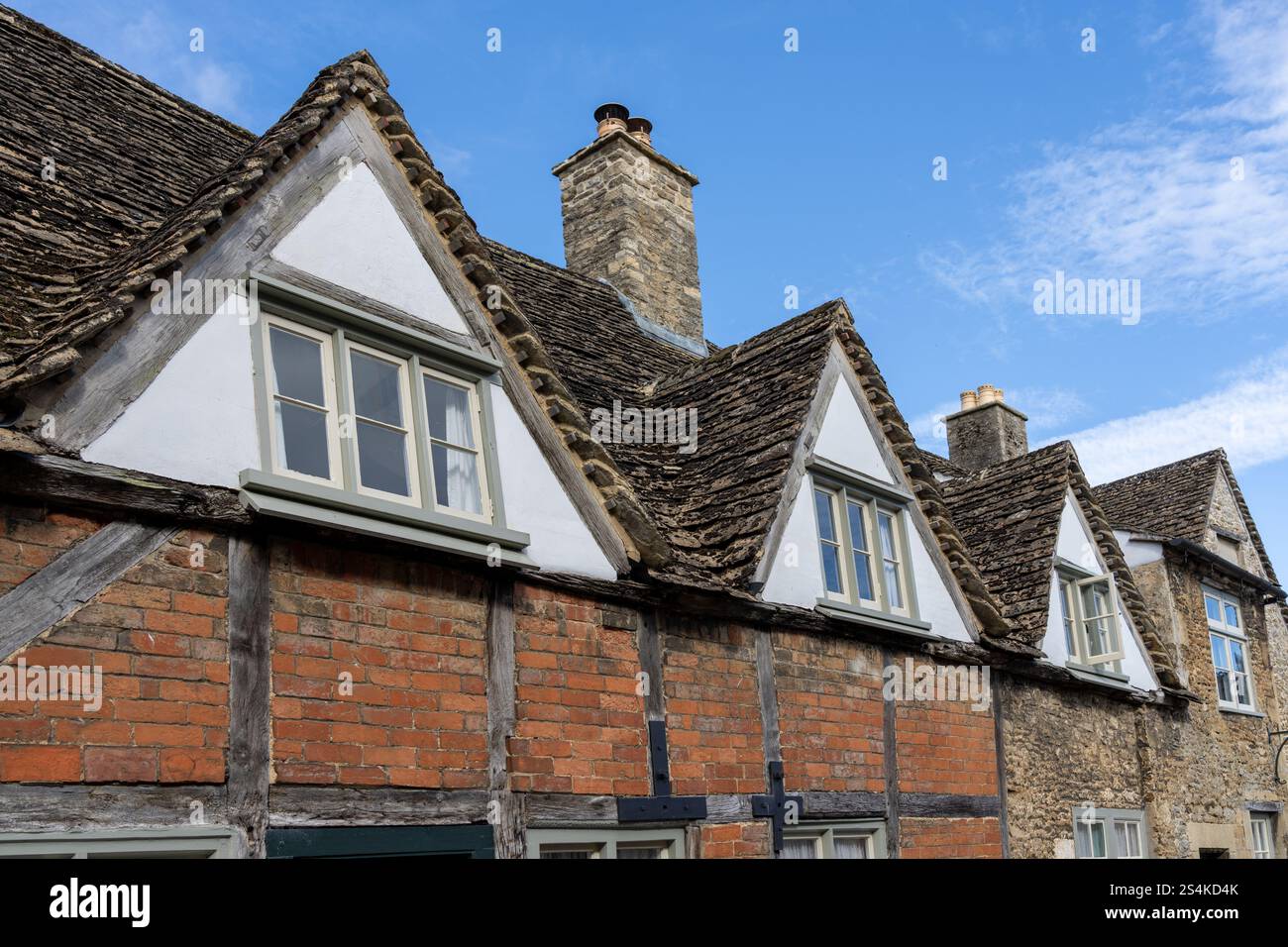 Dormer roof and windows example in row on half-timbered brick house in ...