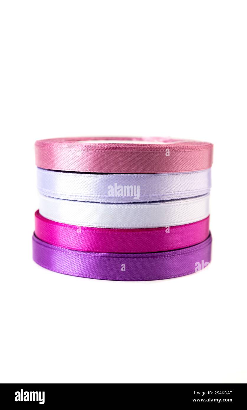 stack of satin ribbons in shades of purple against a white background ...