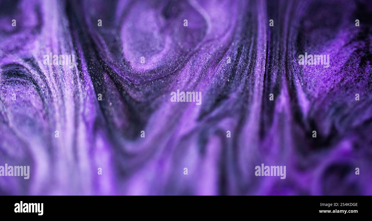 Paint spill. Shimmering liquid. Defocused purple blue black color ...