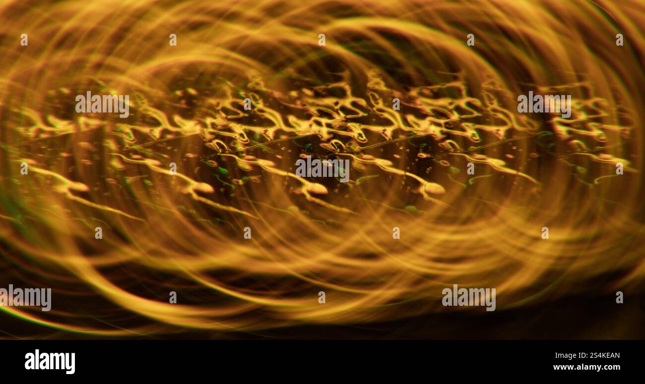 Sparkling liquid. Defocused glow. Golden yellow color lens flare ...