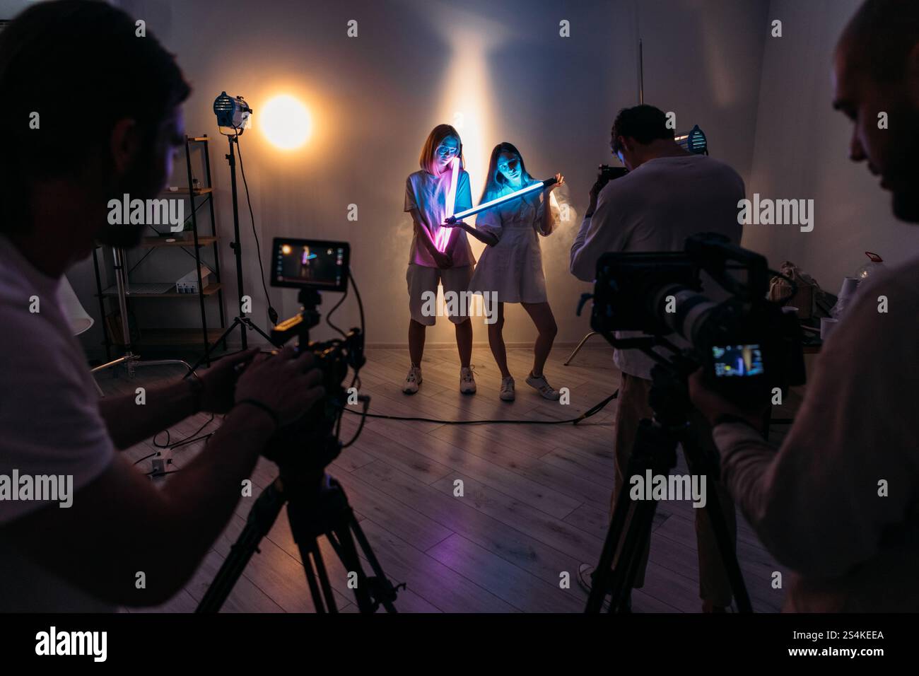 Ultraviolet model. Nightlife studio. Girls pose photo with led lamps in ...