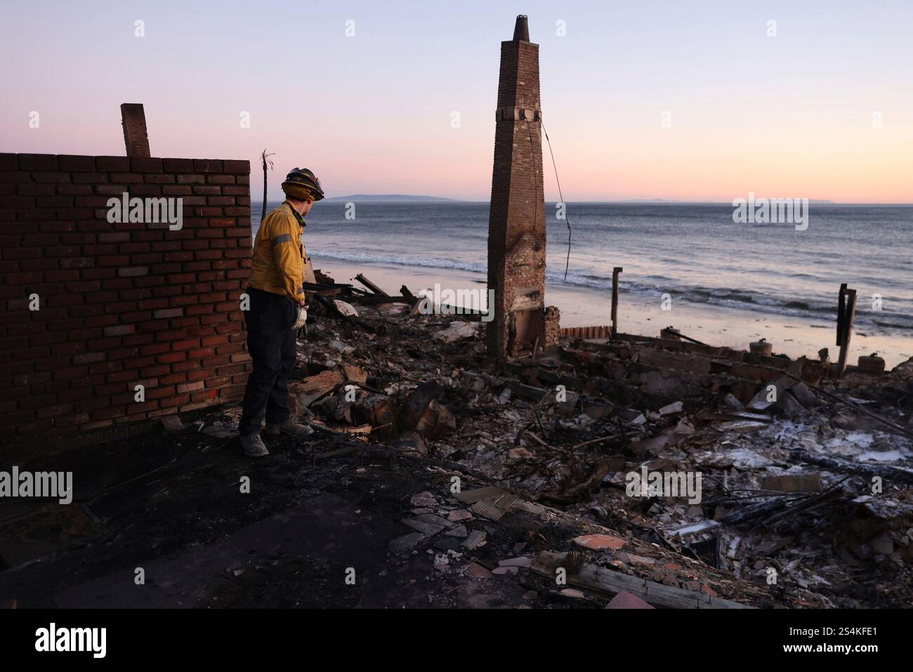 Los Angeles Fire Department's Dylan Casey looks for hot spots at a ...