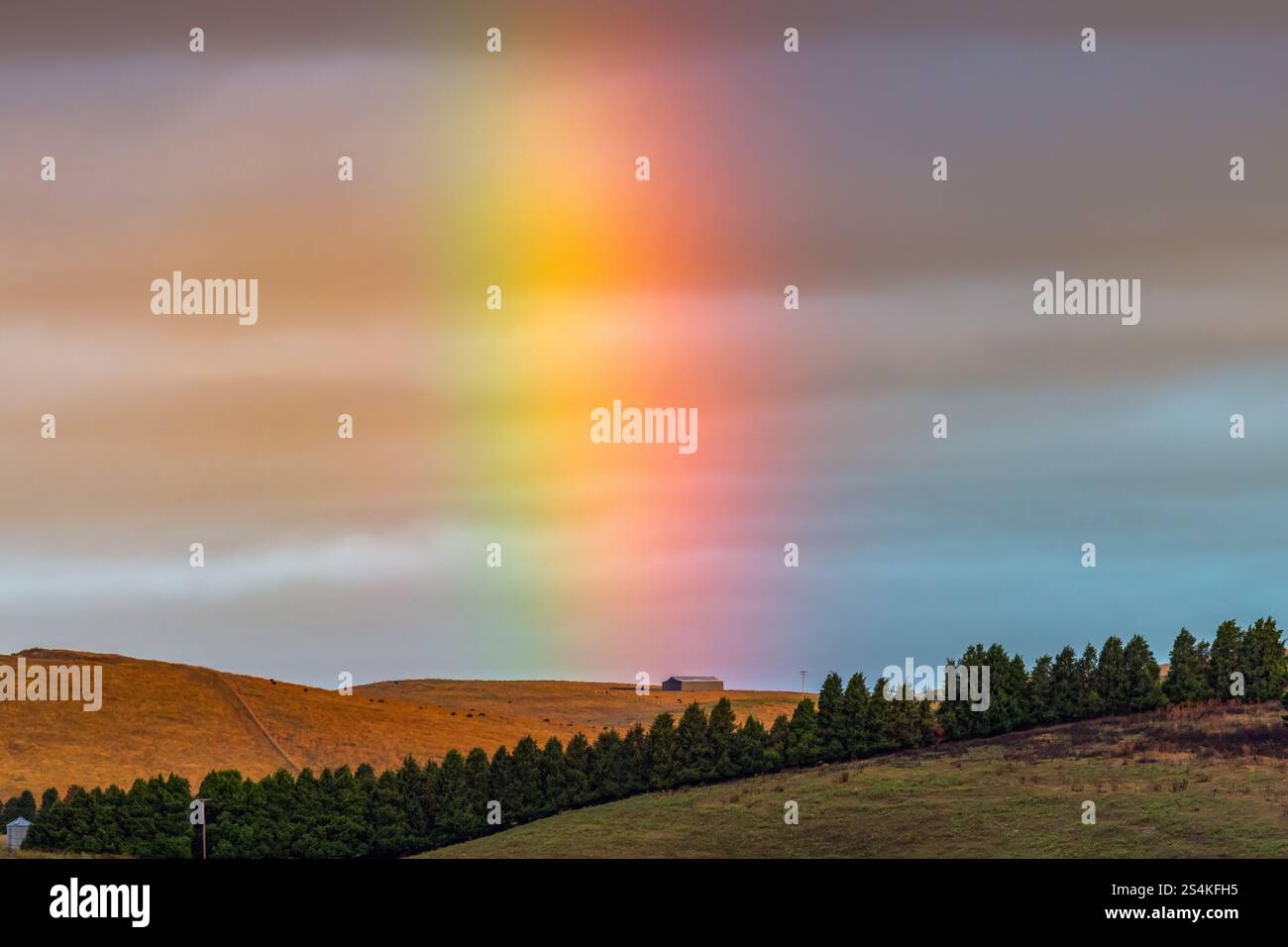 Sunset rainbow over the countryside at Blayney in the Central West of ...
