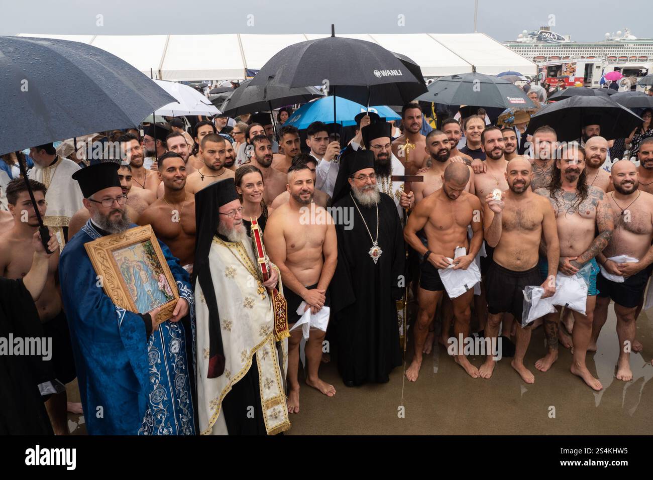 Participants and holy men of the church pose for a group photo. The ...