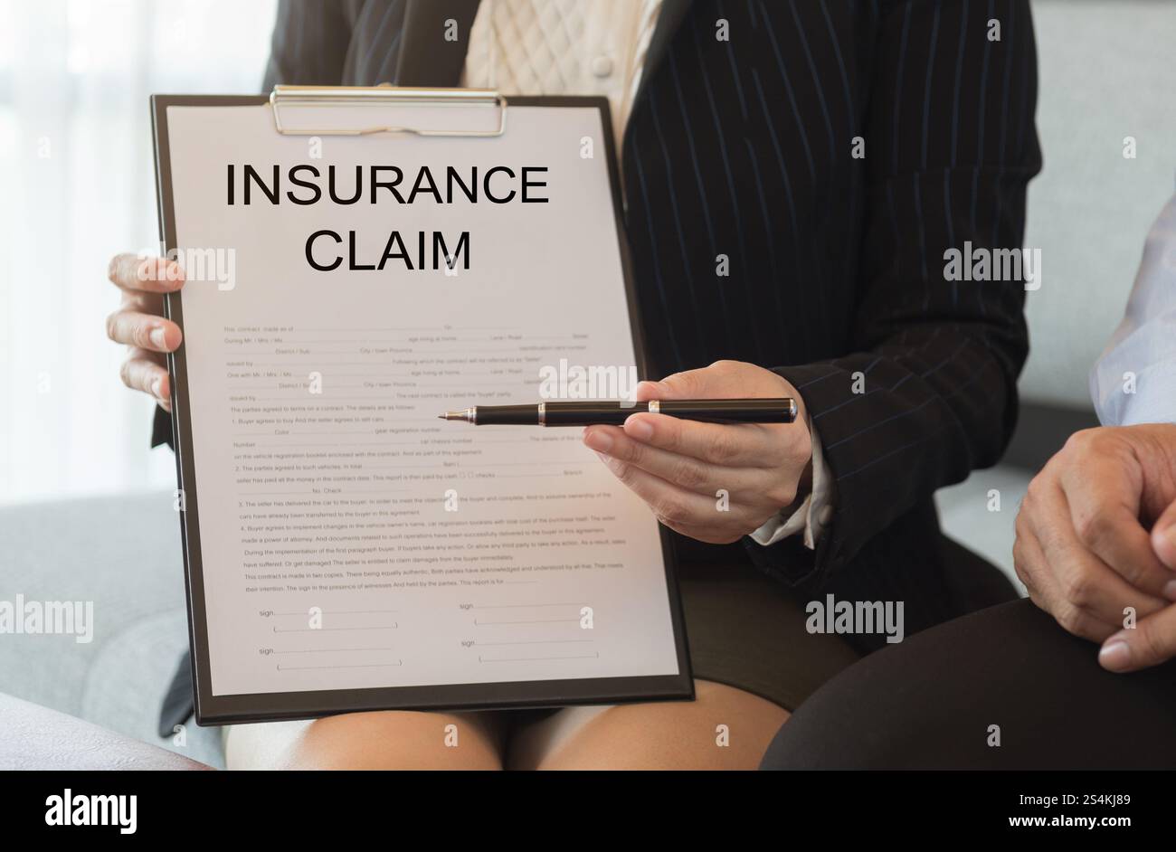 Insurance agent sends pen and insurance claim form for signing contract ...