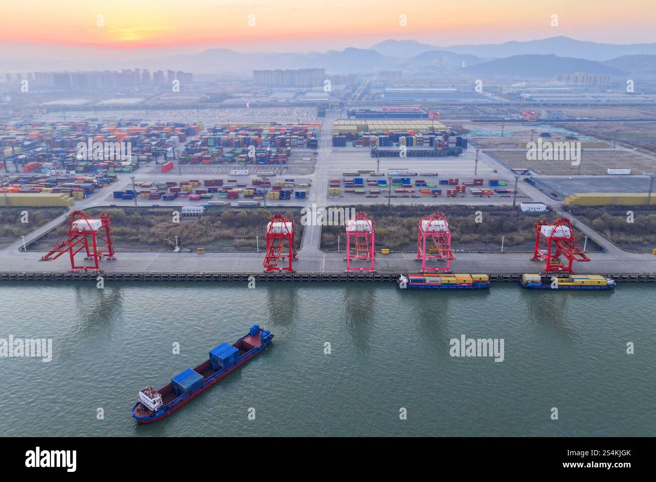 Cargo ships are docked for loading and unloading operations at the ...