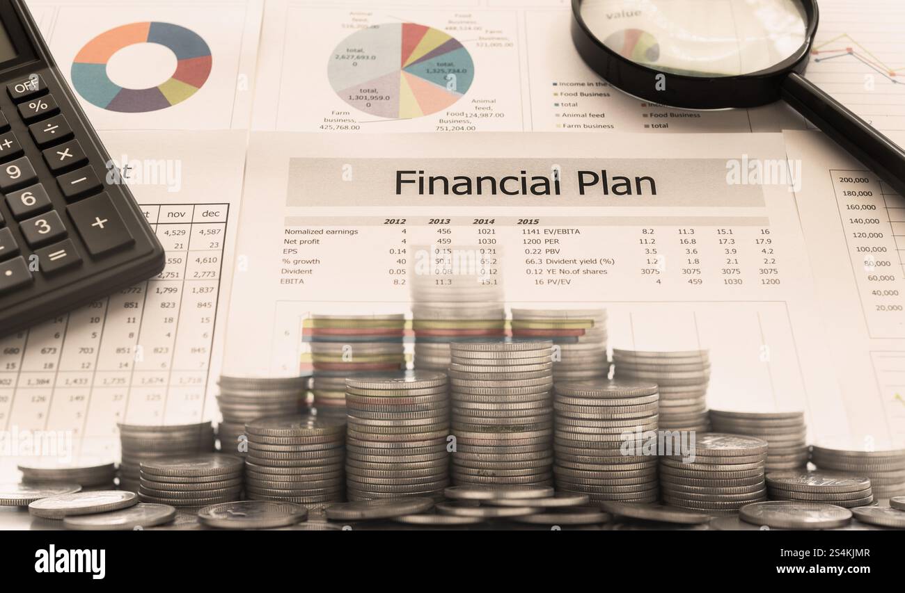 Business graphs and charts report with magnifying glass, calculator ...