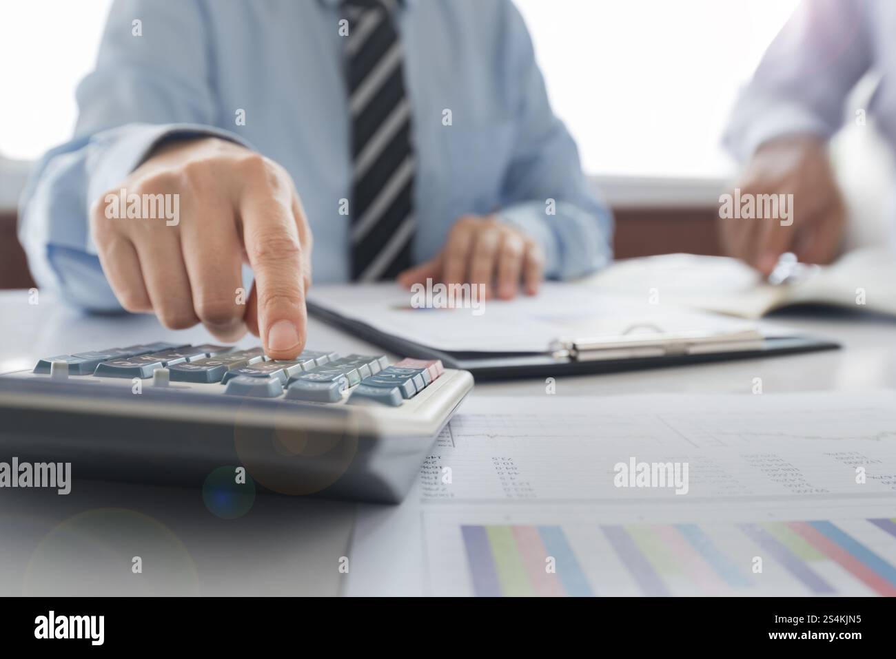 Businessman using a calculator to calculate the numbers. Accounting ...
