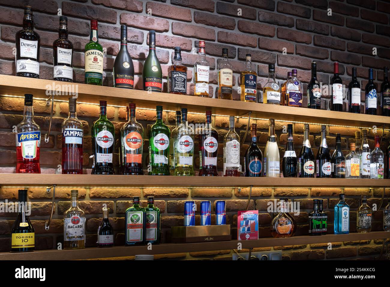 This is a vibrant and colorful collection of liquor bottles that are ...