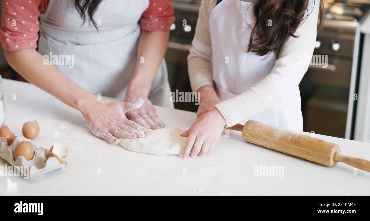 Hands, cooking and mother with child in kitchen with dough for learning with pizza dinner ...