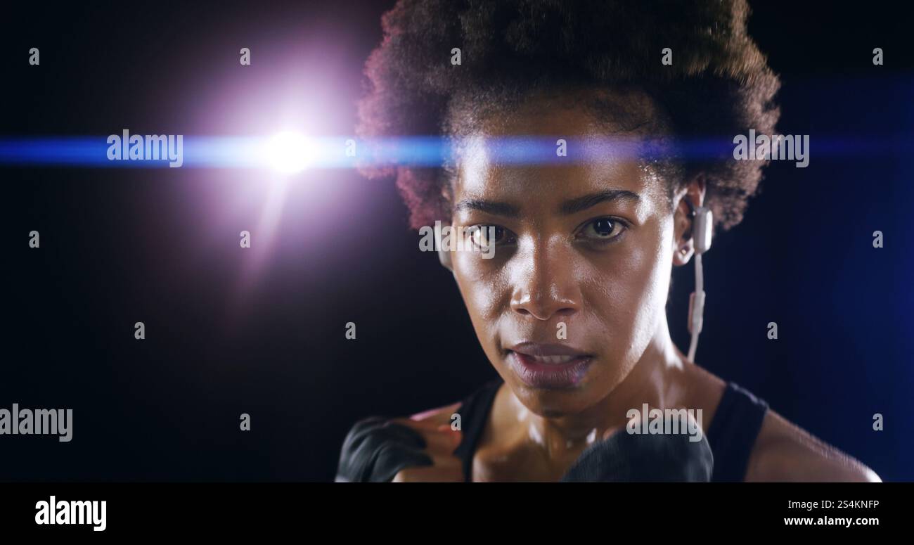 Woman, boxer fighter and studio for workout, sweating and lens flare on ...