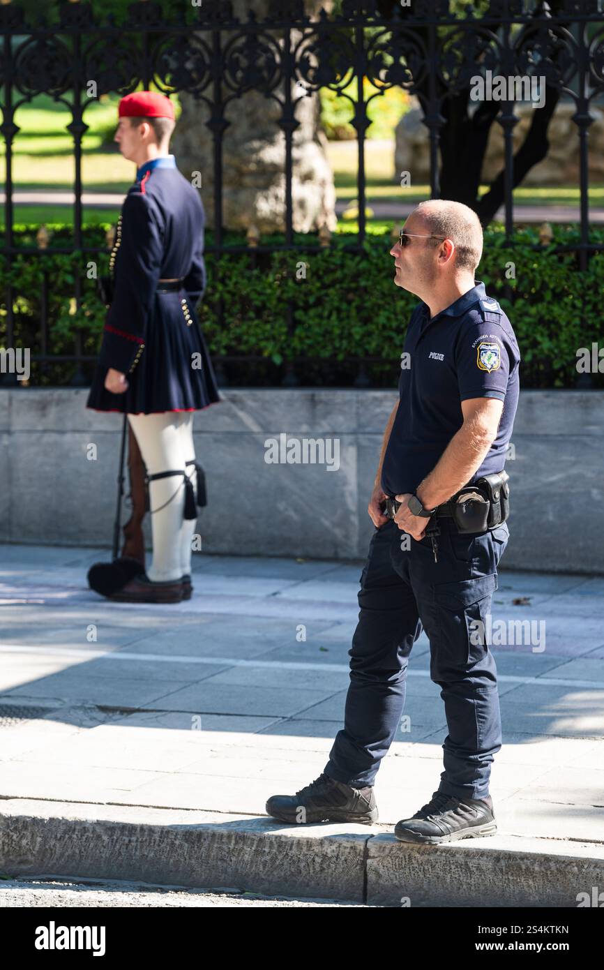 Evzone security guard and policeman on the street at the presidential ...