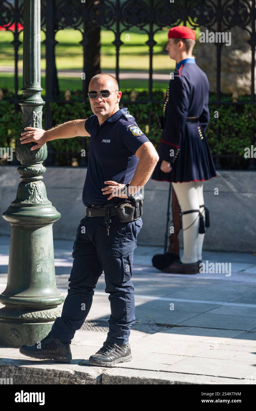 Evzone security guard and policeman on the street at the presidential ...