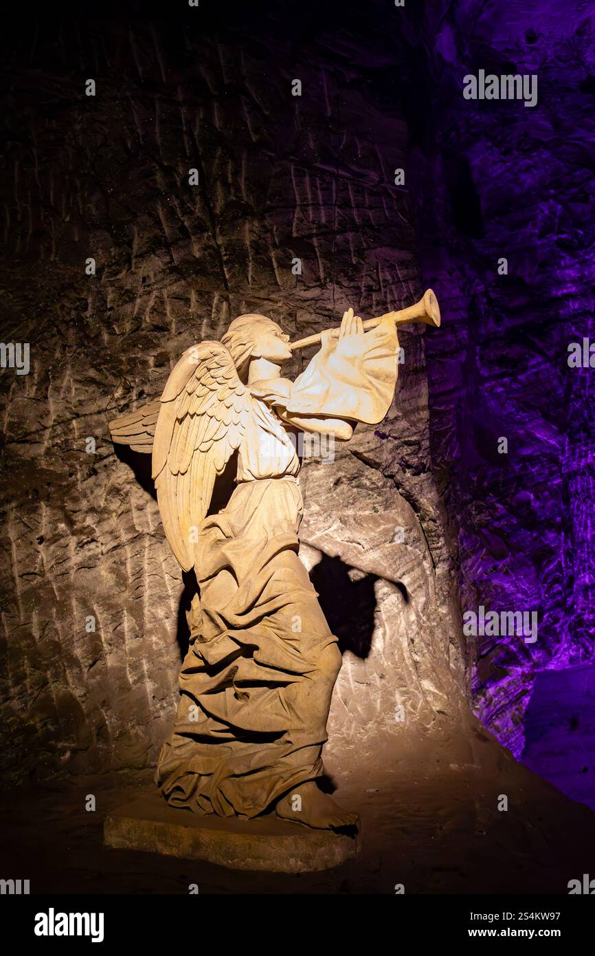 Stone statue of an angel blowing a trumpet, intricately carved with ...