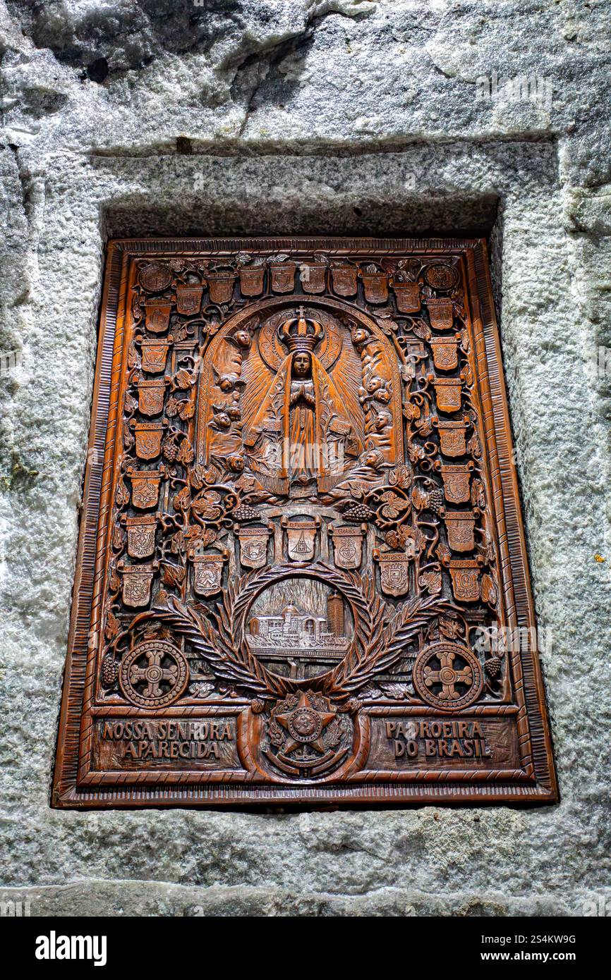 Intricately carved wooden religious panel featuring Nossa Senhora ...