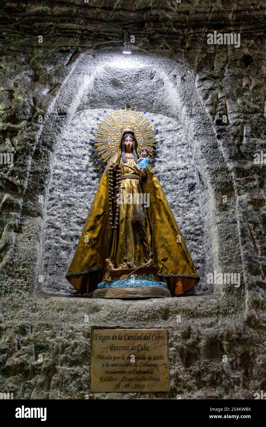 Religious statue of the Virgin Mary displayed on the textured stone ...