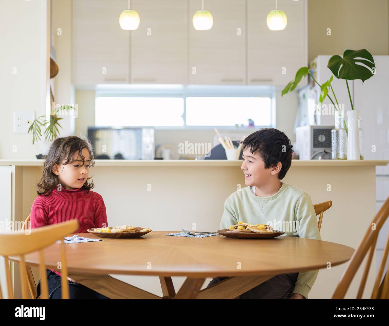 Kids Enjoying Pancakes at the Dining Table Stock Photo - Alamy