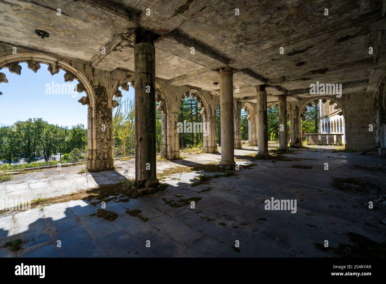 Abandoned palace veranda with ancient columns and arches surrounded by ...