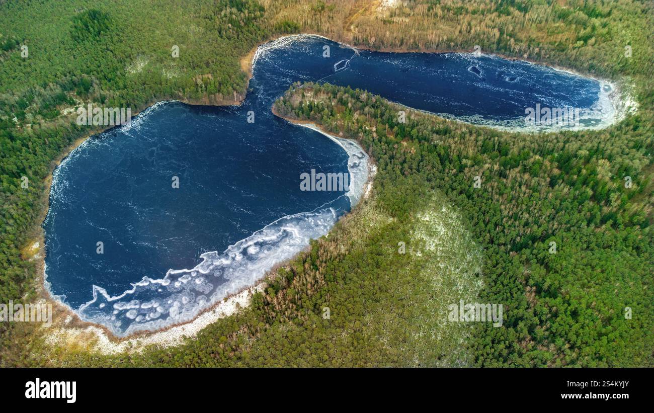 Aerial view of a lakes in the forests of Lithuania, wild winter nature ...