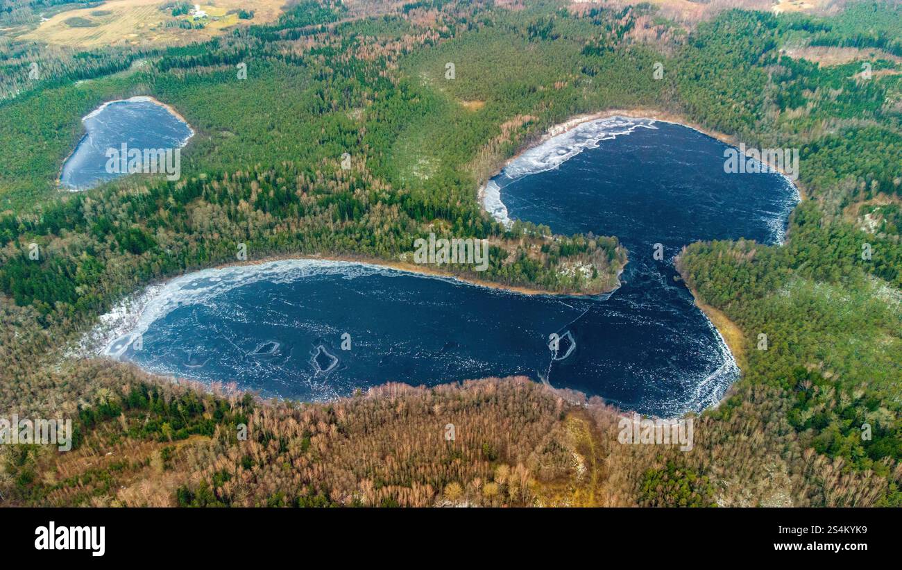 Aerial view of a lakes in the forests of Lithuania, wild winter nature ...