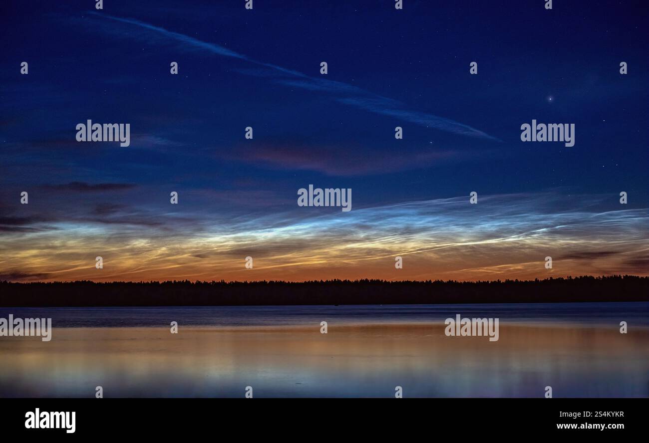 Lake at night, sky with stars, reflection in water, noctilucent clouds ...