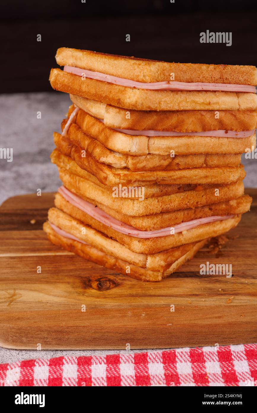 An appetizing display of ham and cheese sandwiches stacked vertically ...