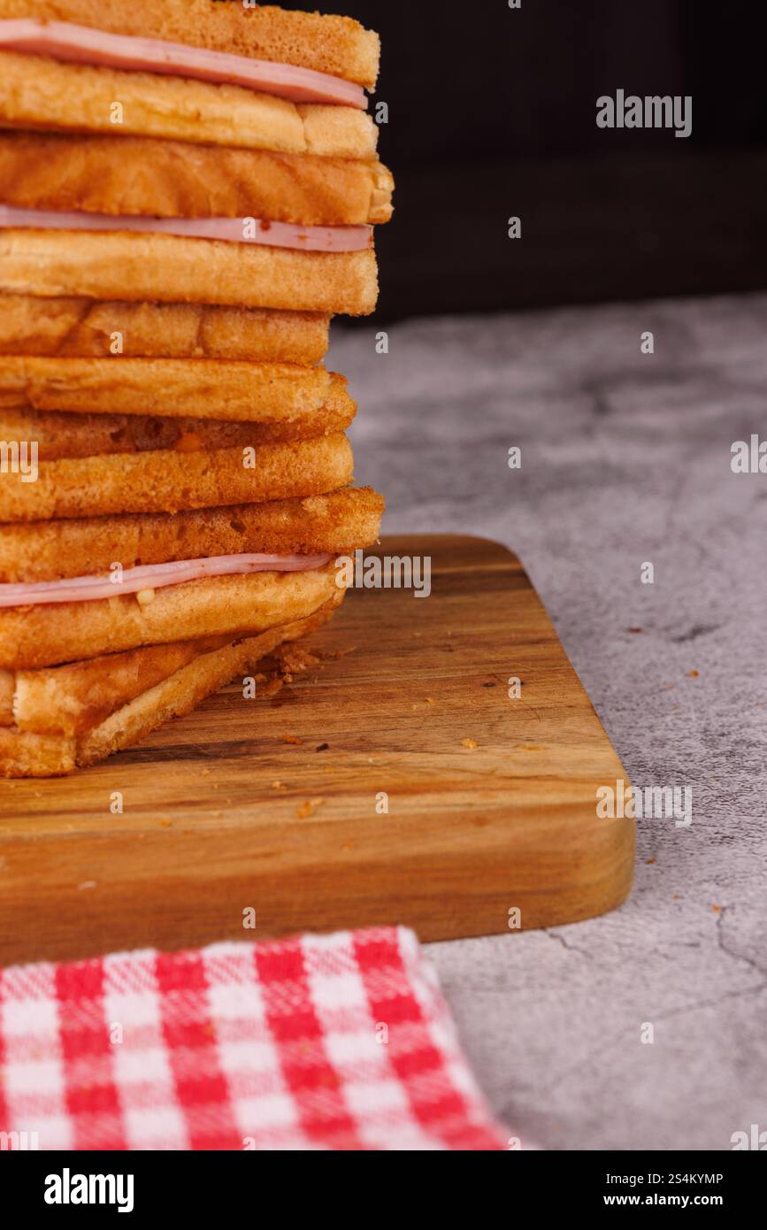 A mouthwatering display of ham and cheese sandwiches stacked vertically ...