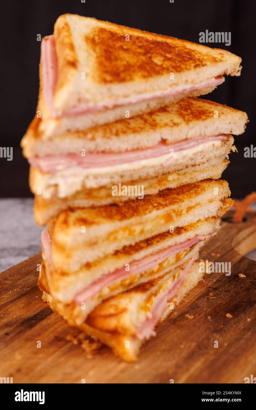 A charming vertical arrangement of ham and cheese sandwiches cut in ...