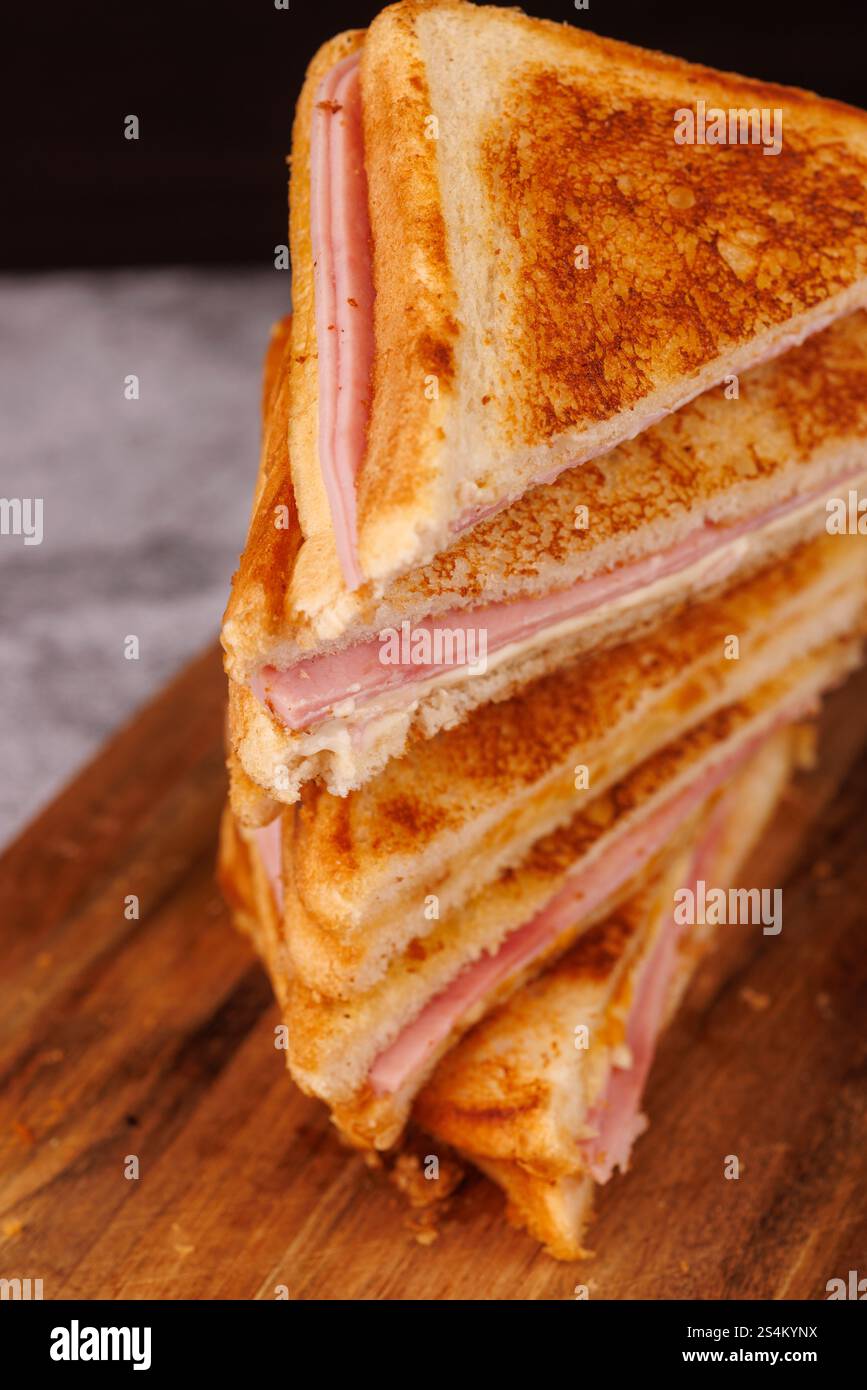 A charming display of ham and cheese sandwiches forming a vertical ...
