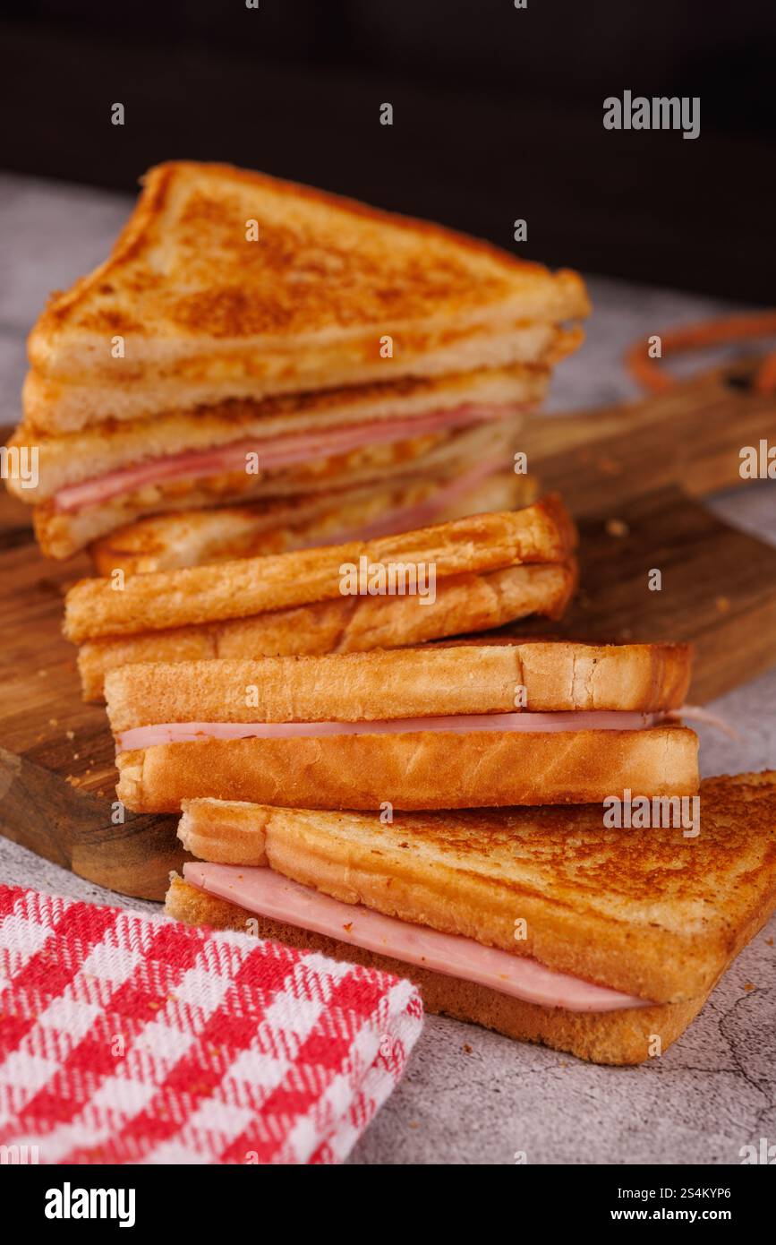 A mouthwatering display of ham and cheese sandwiches forming a vertical ...