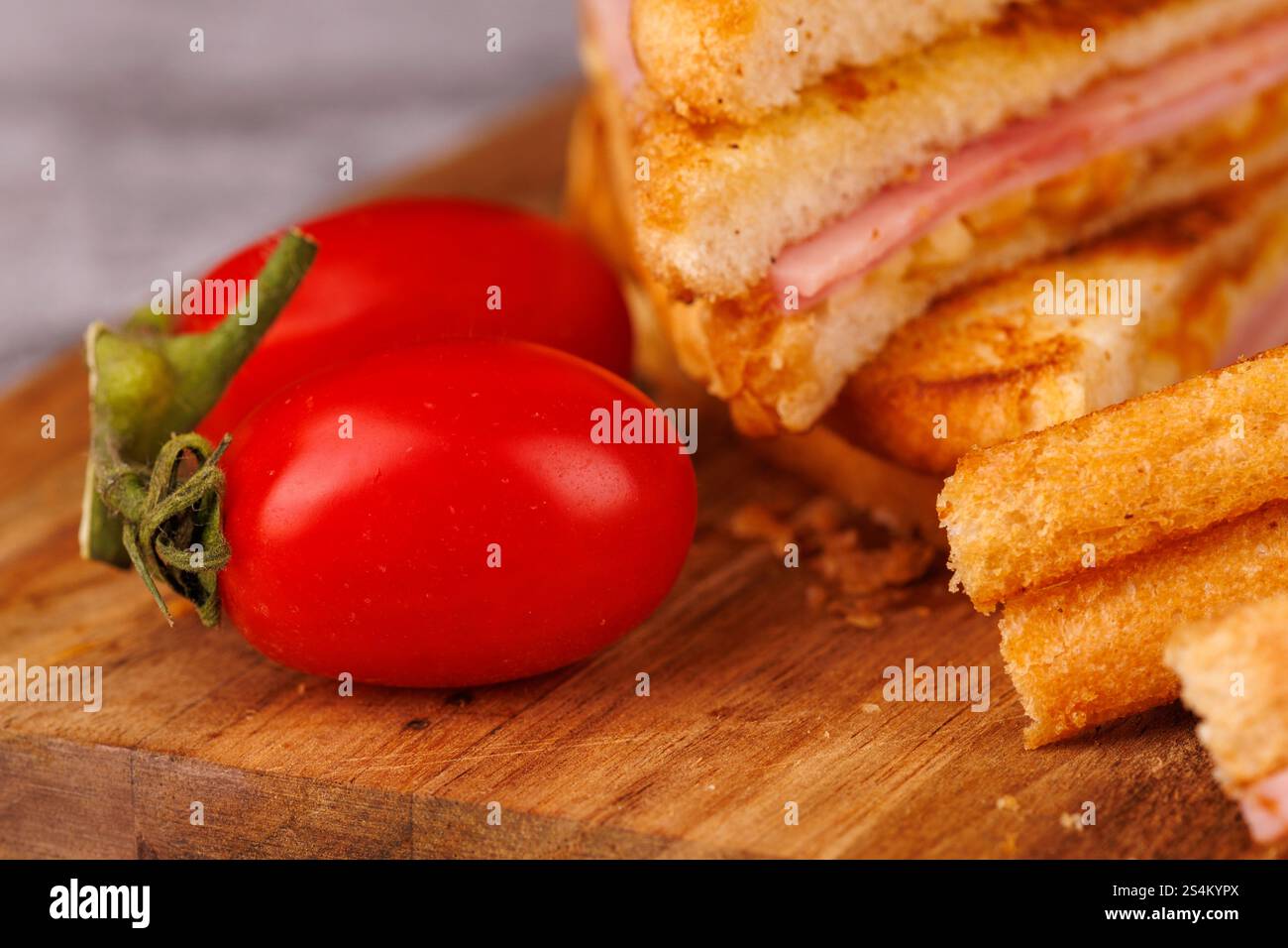 A vibrant display of ham and cheese sandwiches cut in half, forming a ...