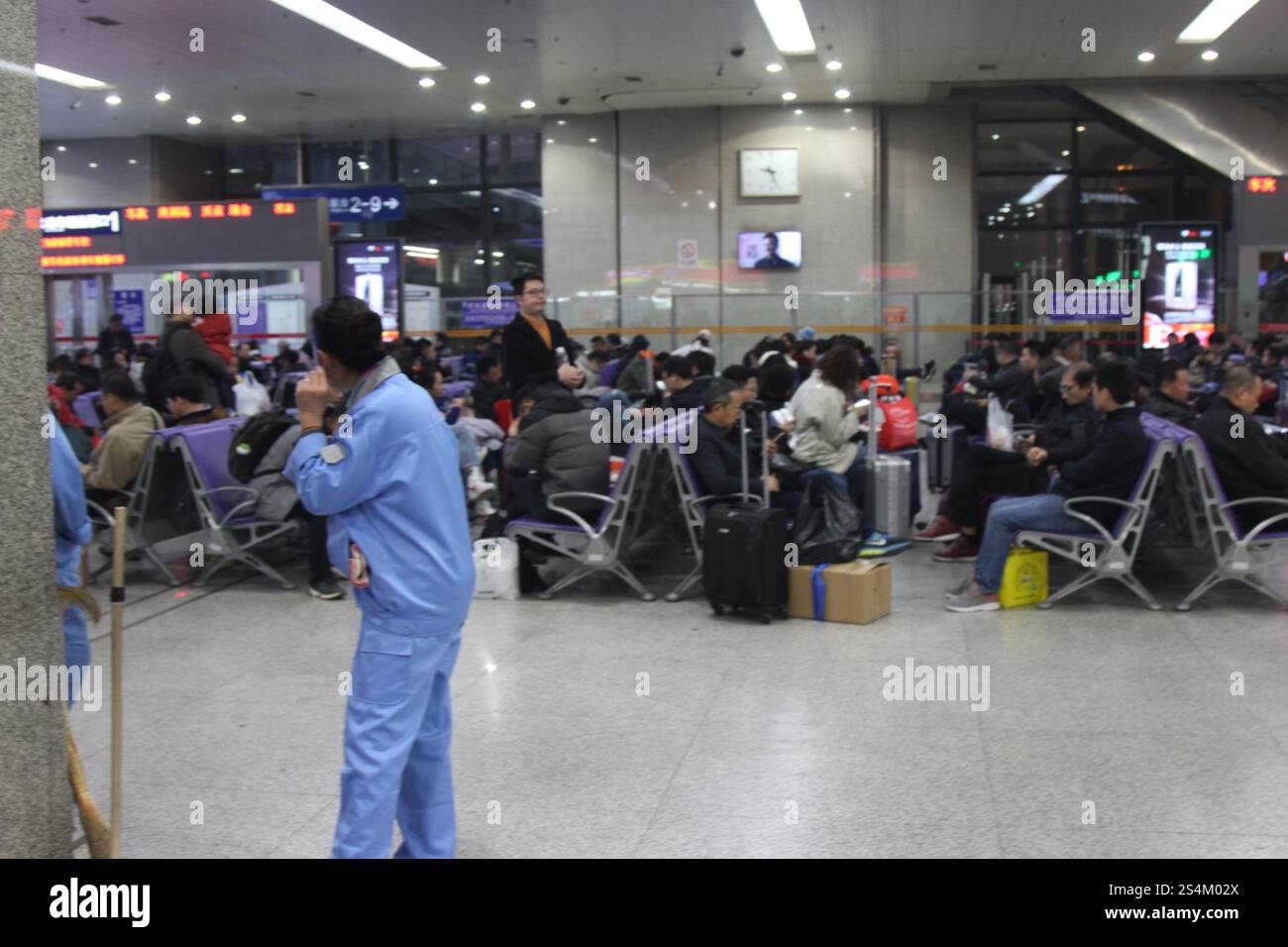 People wait for trains at a railway station in Chongqing, China, 9 ...