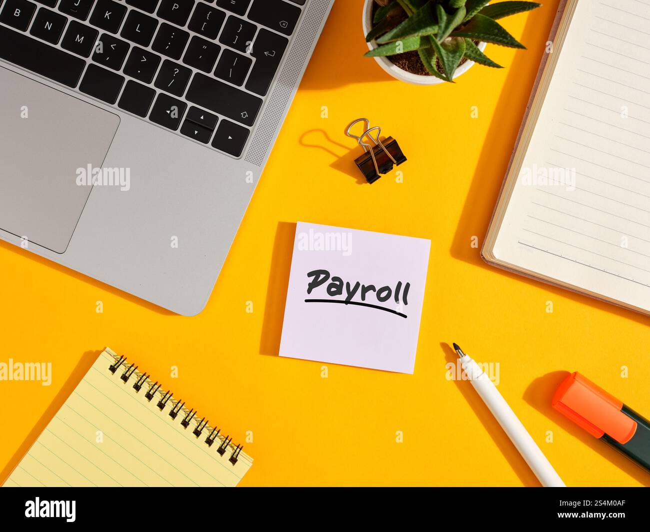 Office desktop with sticky note with payroll word, human resource ...