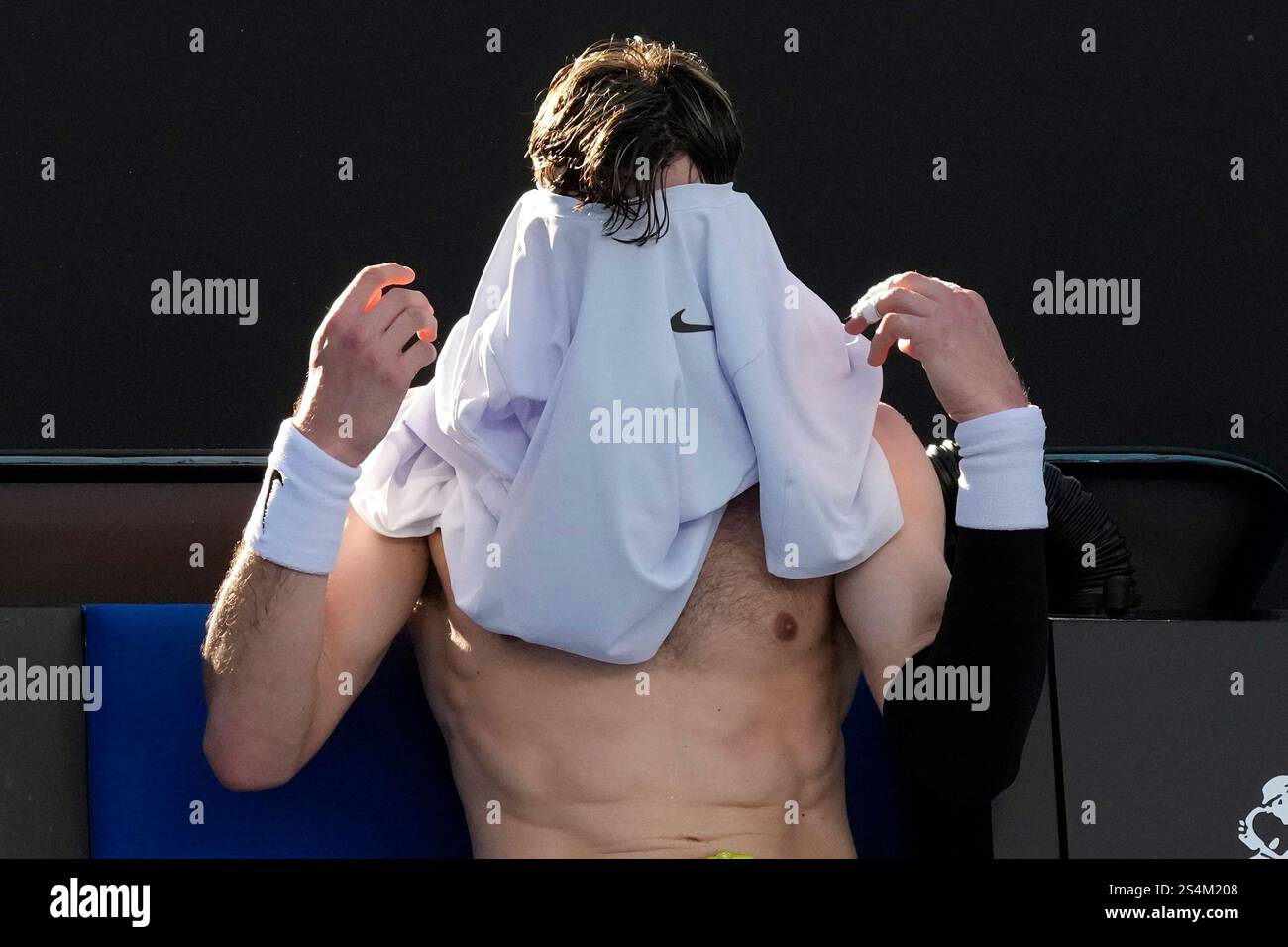 Jack Draper of Britain changes his shirt during a break in his first ...