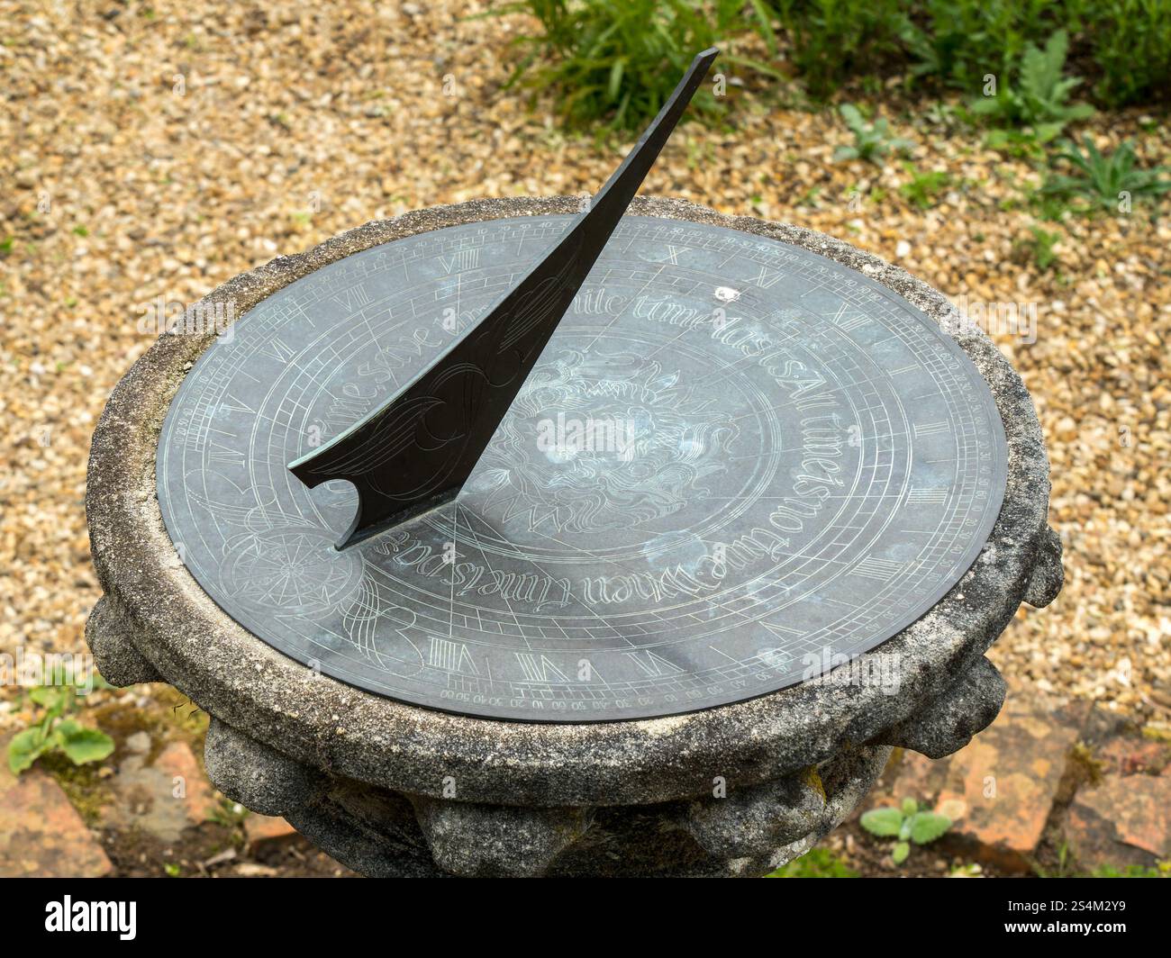 Pretty, ornate, engraved metal / bronze garden sundial on stone ...