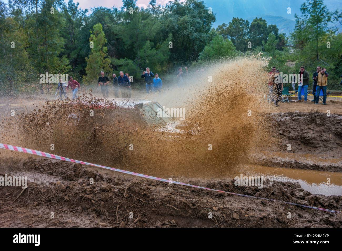 off-road vehicle navigating through a challenging mud track, showcasing ...