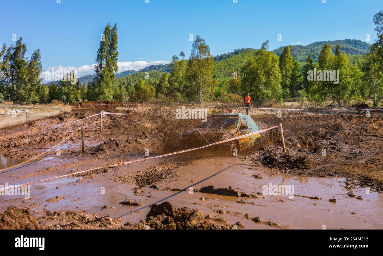 an off-road vehicle powering through a challenging mud track ...