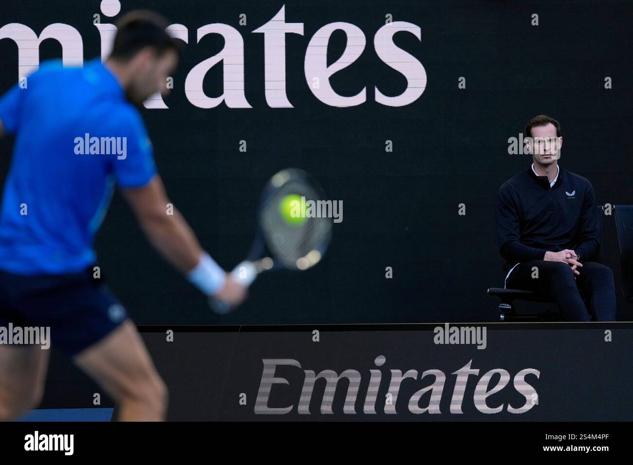 Andy Murray, coach of Novak Djokovic of Serbia watches him during his ...
