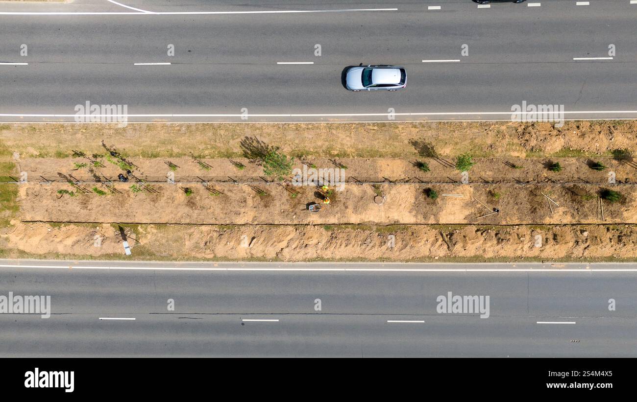 Aerial view of a highway with a car and a median strip under ...