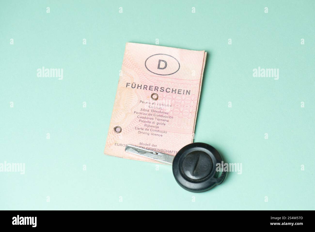 Old obsolete pink german driving license with a car key, exchange ...