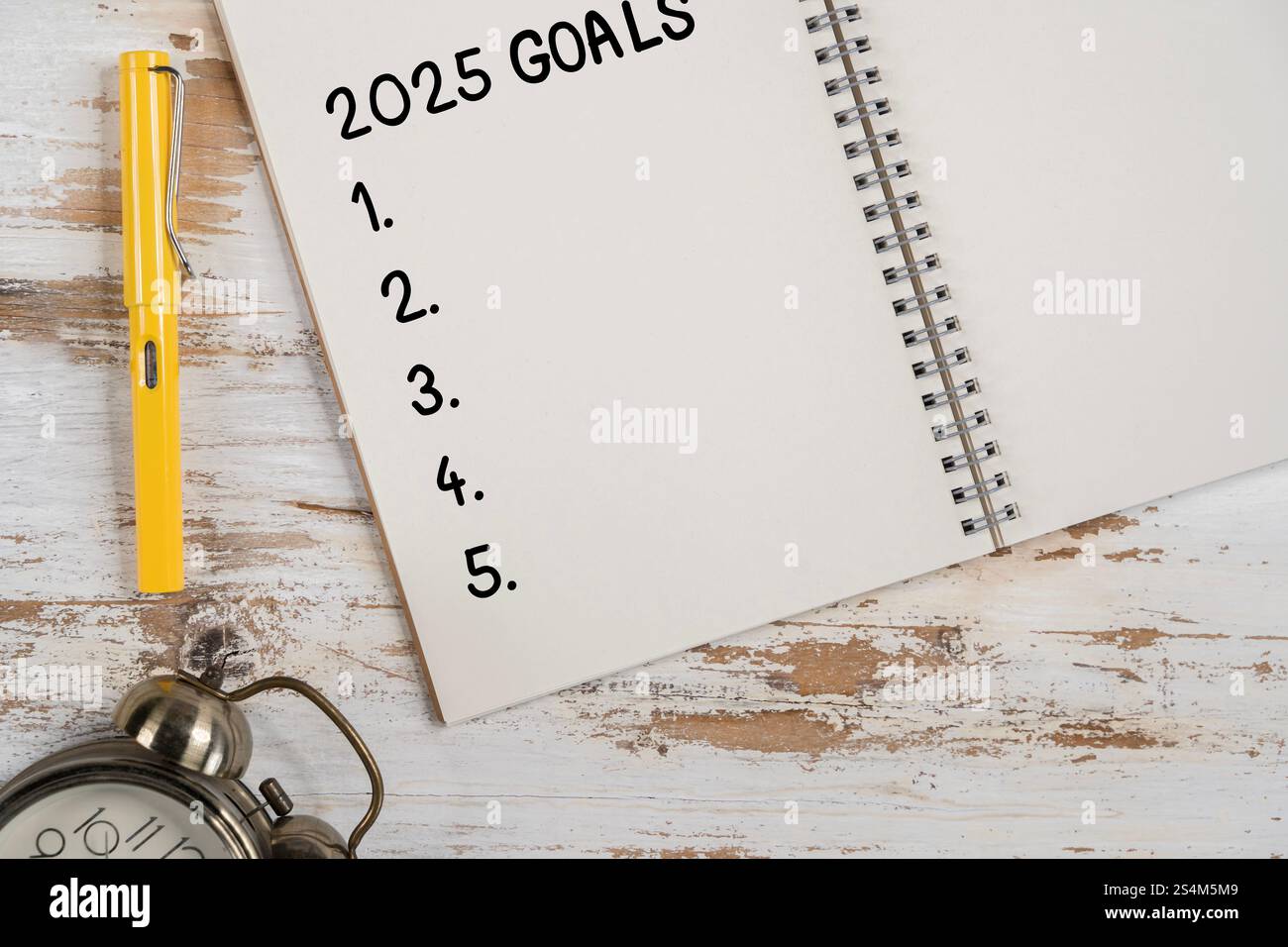 Goals concept. Notebook with goals list, cup of tea on wooden table ...